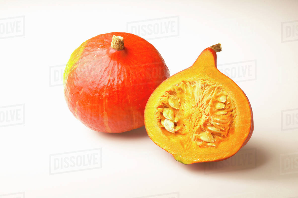 Whole and half Hokkaido squash - Stock Photo - Dissolve