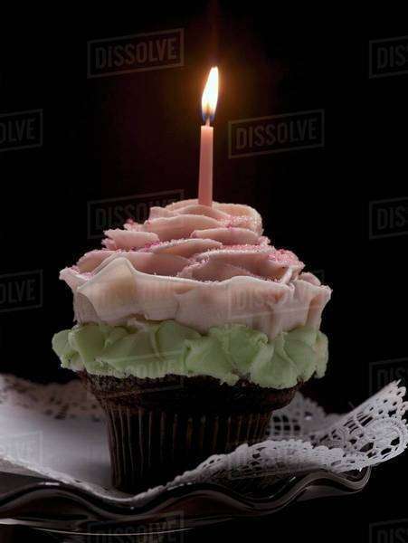 A cupcake with a candle - Stock Photo - Dissolve