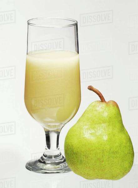 A glass of pear juice with a pear - Royalty-free Stock Photo | Dissolve
