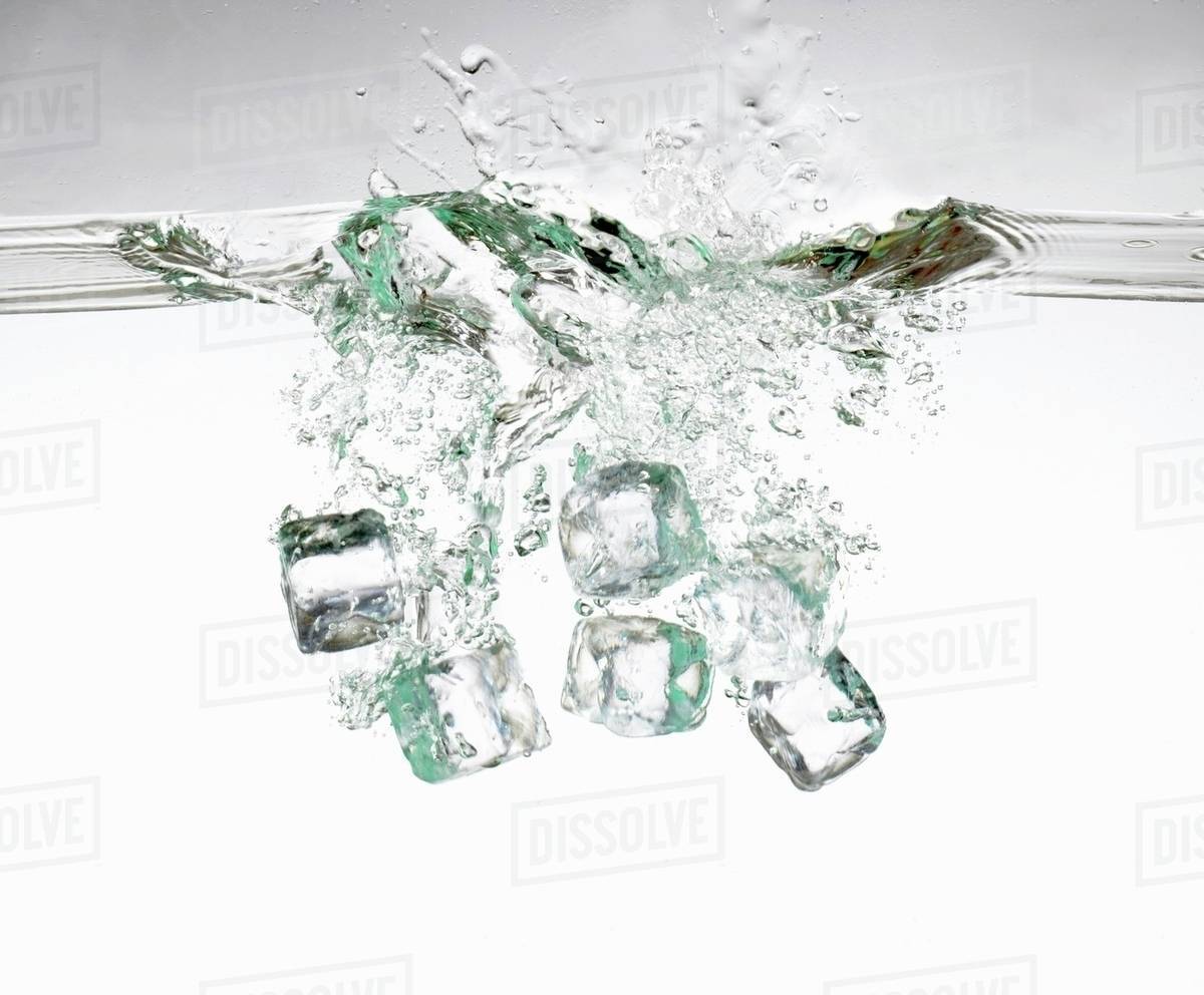 Several ice cubes falling into water - Royalty-free Stock Photo | Dissolve