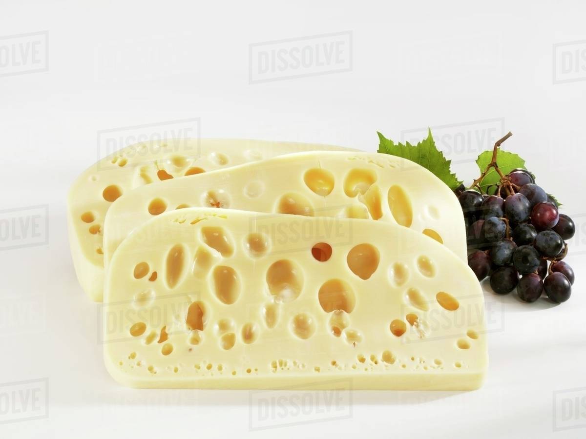 Three slices of Leerdammer cheese with grapes - Royalty-free Stock ...