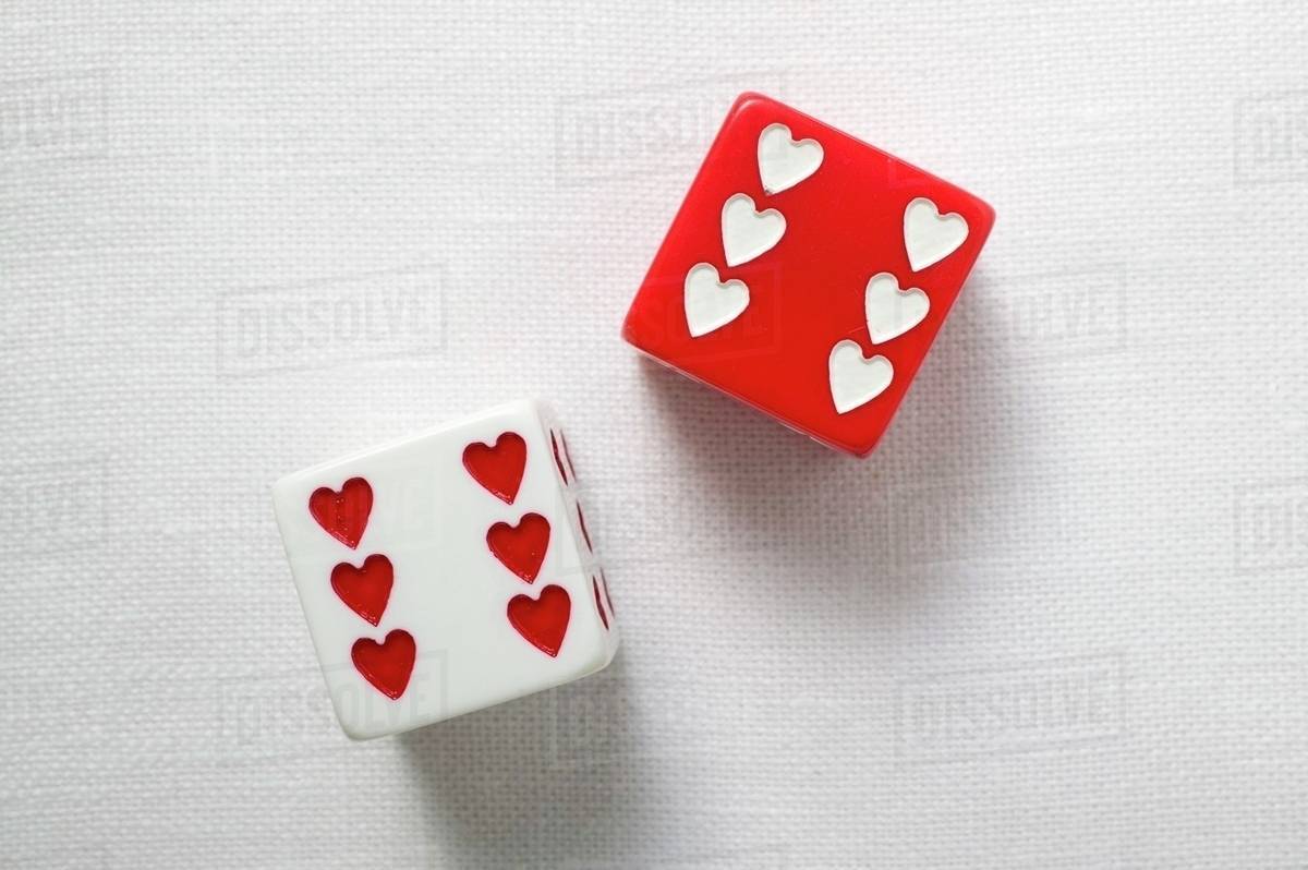 Two dice with hearts for Valentine's Day - Stock Photo - Dissolve