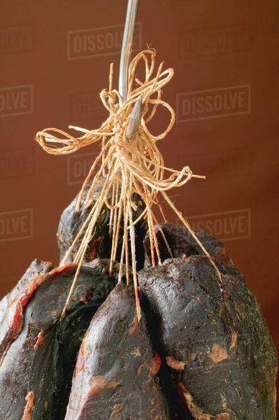 Smoked venison hams (hanging up) - Stock Photo - Dissolve