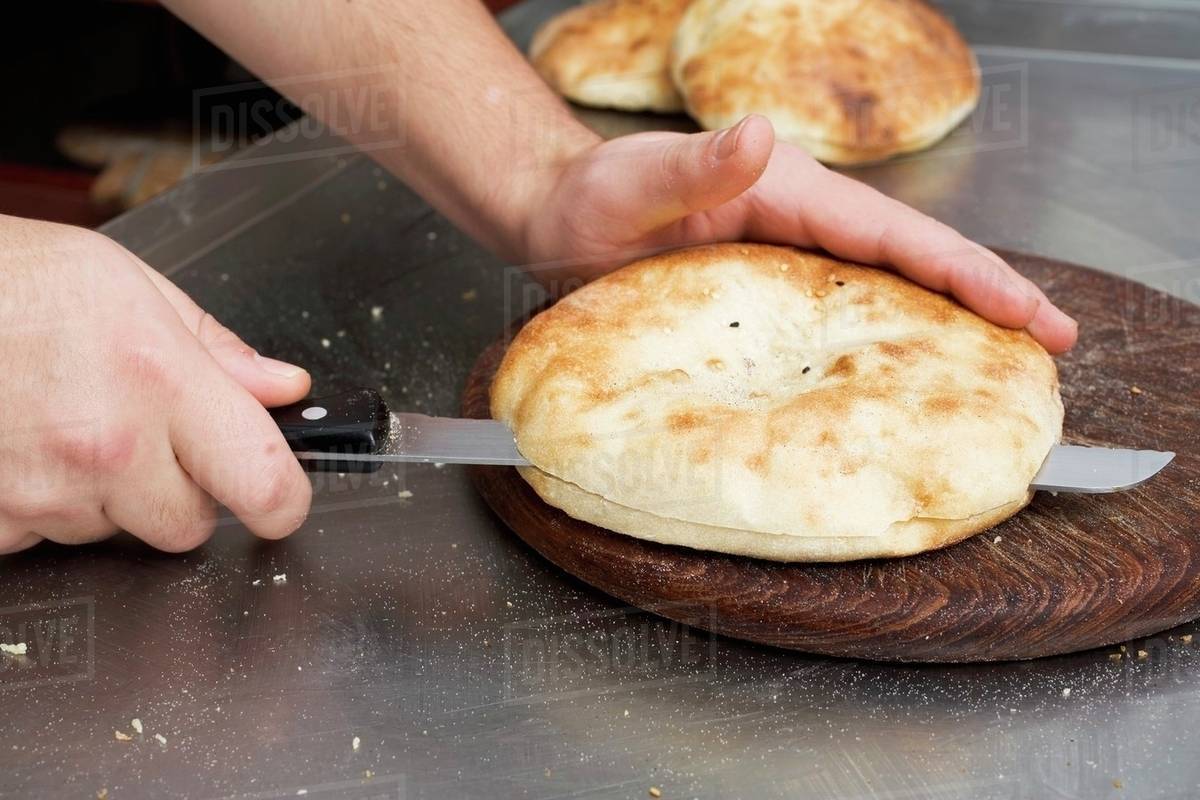 Splitting pita bread - Royalty-free Stock Photo | Dissolve