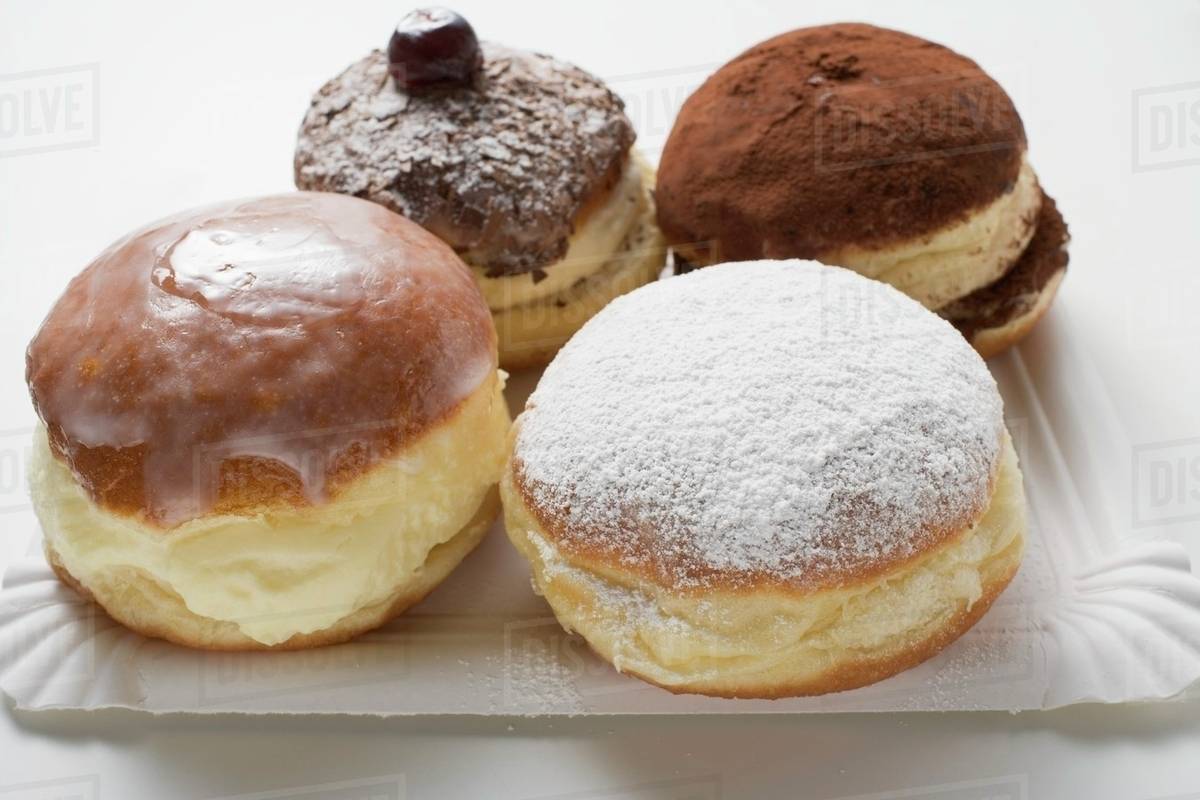 Four different doughnuts on paper plate - Royalty-free Stock Photo ...