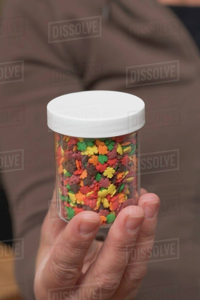 Hand holding a pot of sprinkles for Halloween - Royalty-free Stock ...
