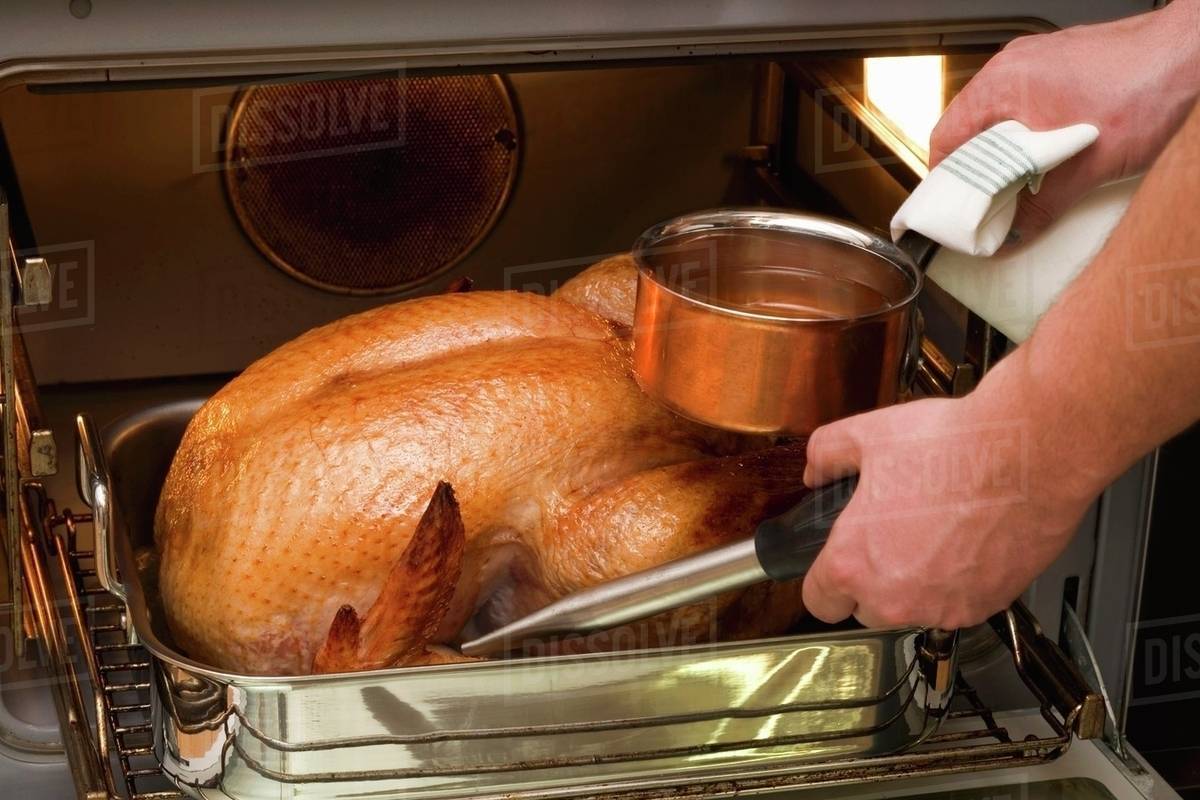 Basting turkey with roasting juices, in the oven - Royalty-free Stock ...
