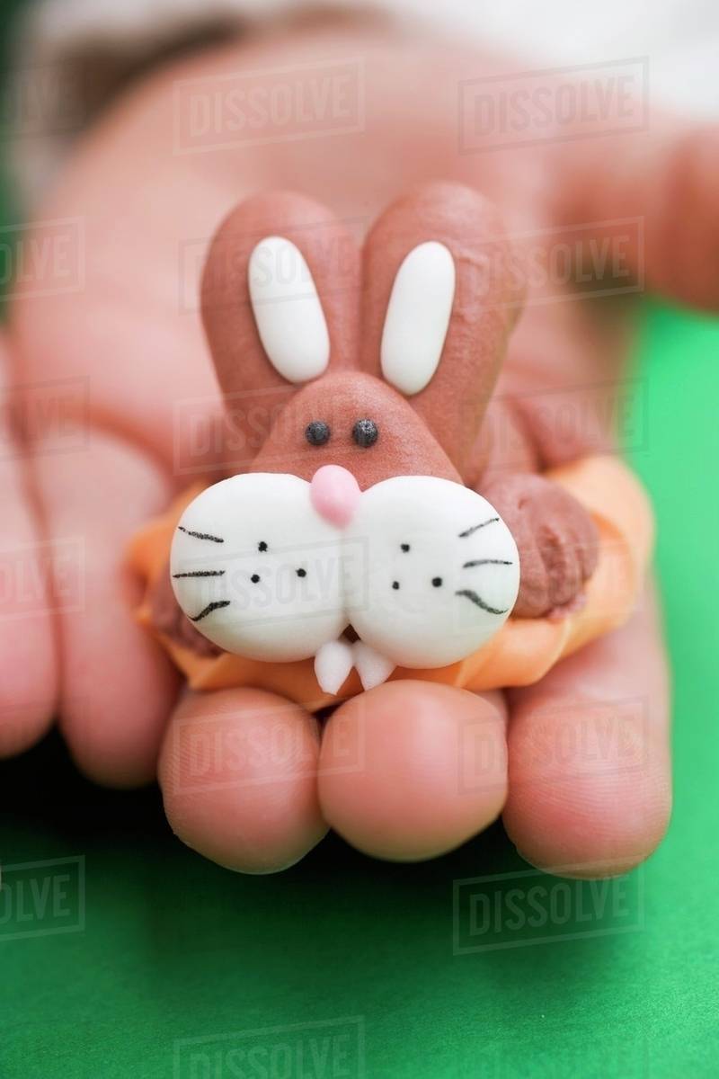 Child's hand holding marzipan Easter Bunny - Royalty-free Stock Photo ...