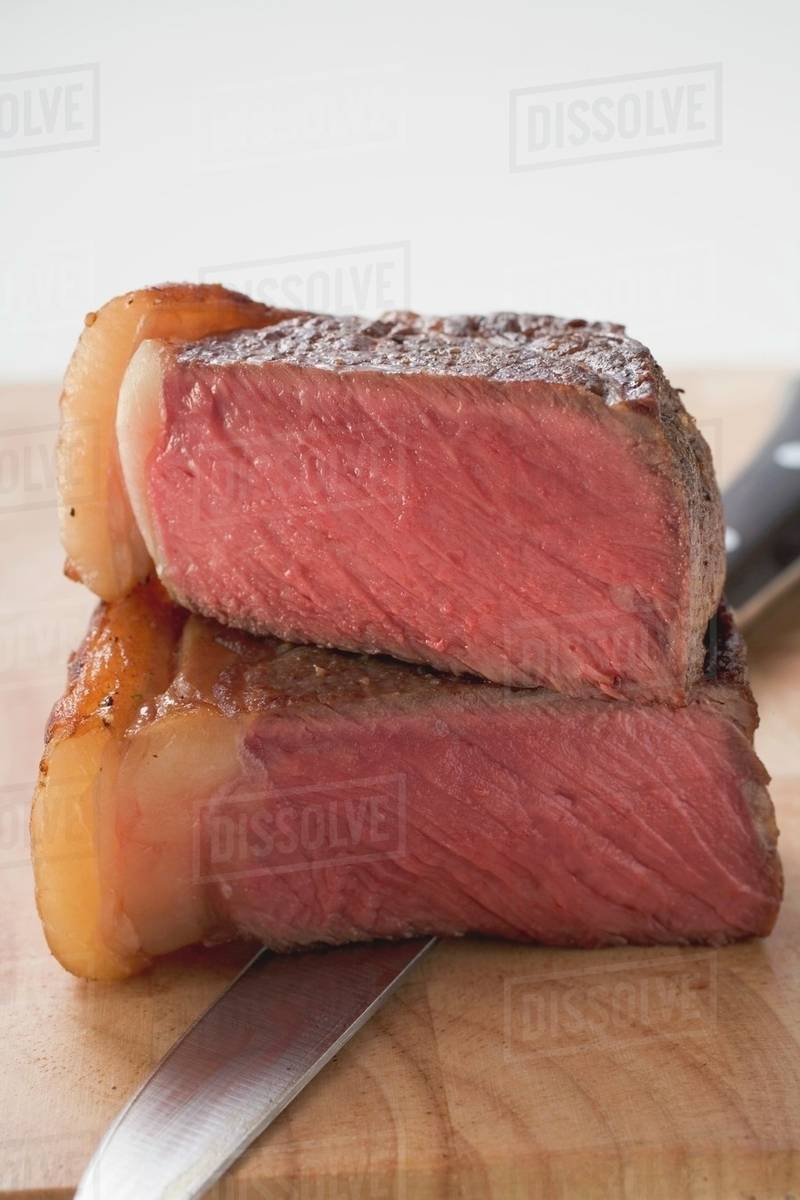 Beef steak with fatty edge, cut in two - Royalty-free Stock Photo ...