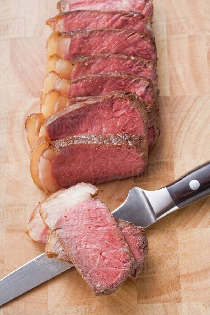 Beef steak with fatty edge, sliced - Royalty-free Stock Photo | Dissolve