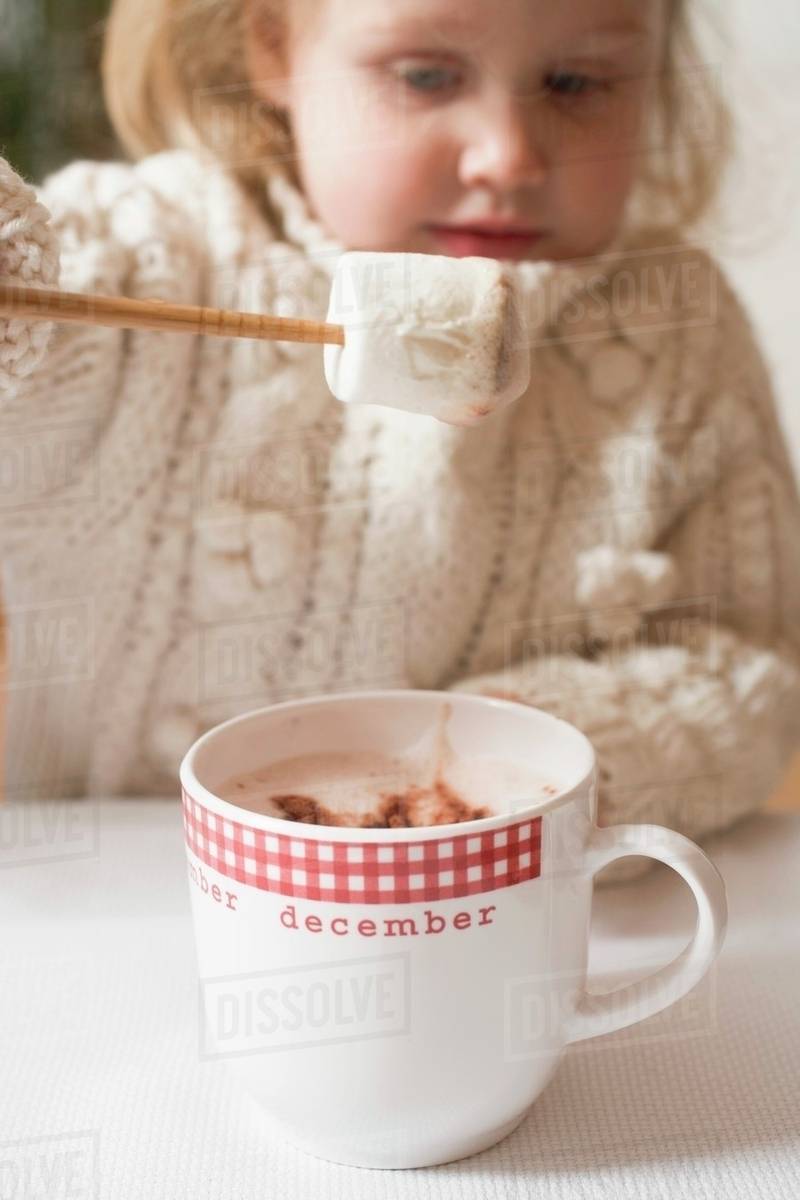 Small girl dipping marshmallow in cocoa - Royalty-free Stock Photo ...