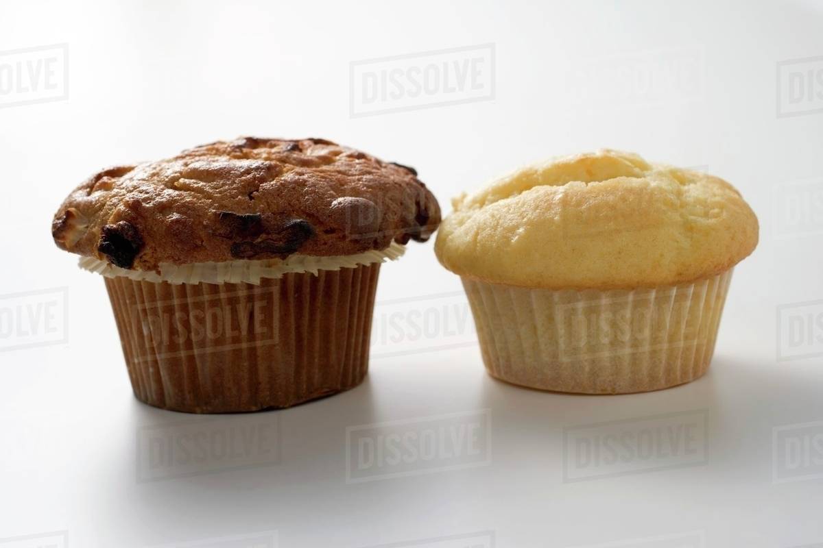 Two different muffins in paper cases - Royalty-free Stock Photo | Dissolve