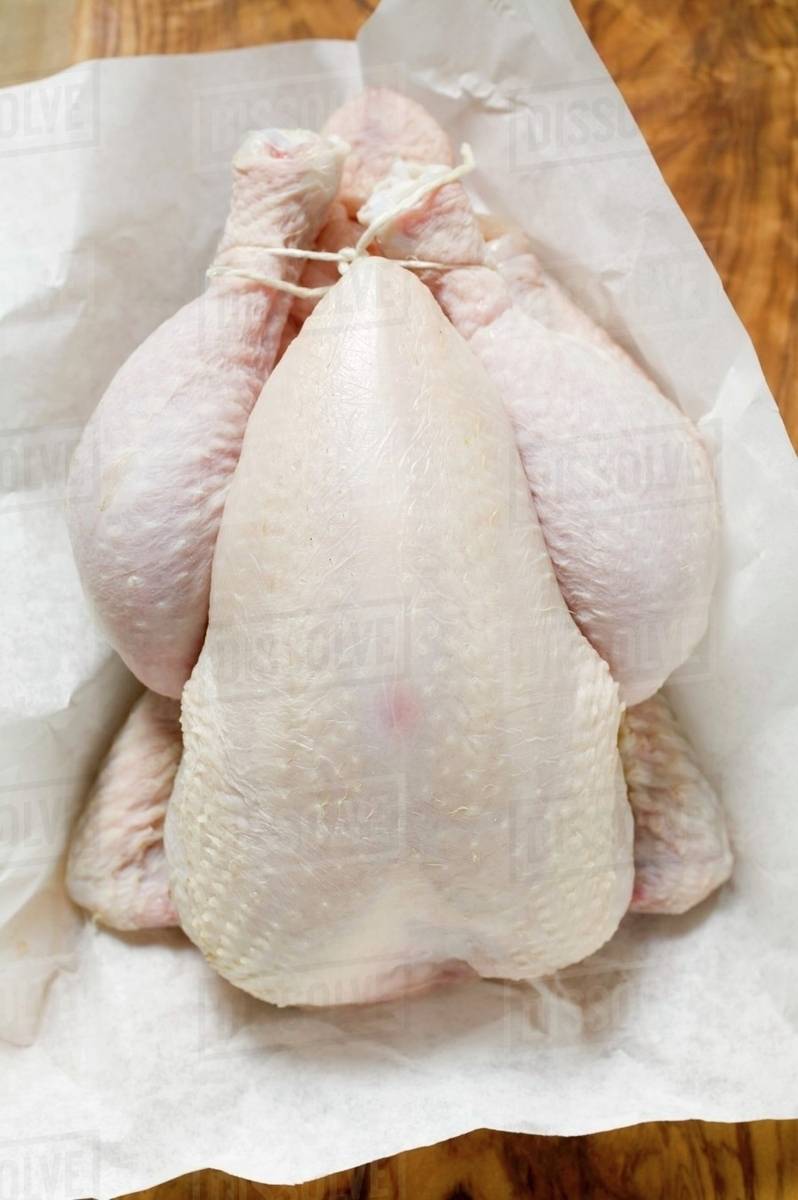 Fresh chicken on paper (overhead view) - Royalty-free Stock Photo ...