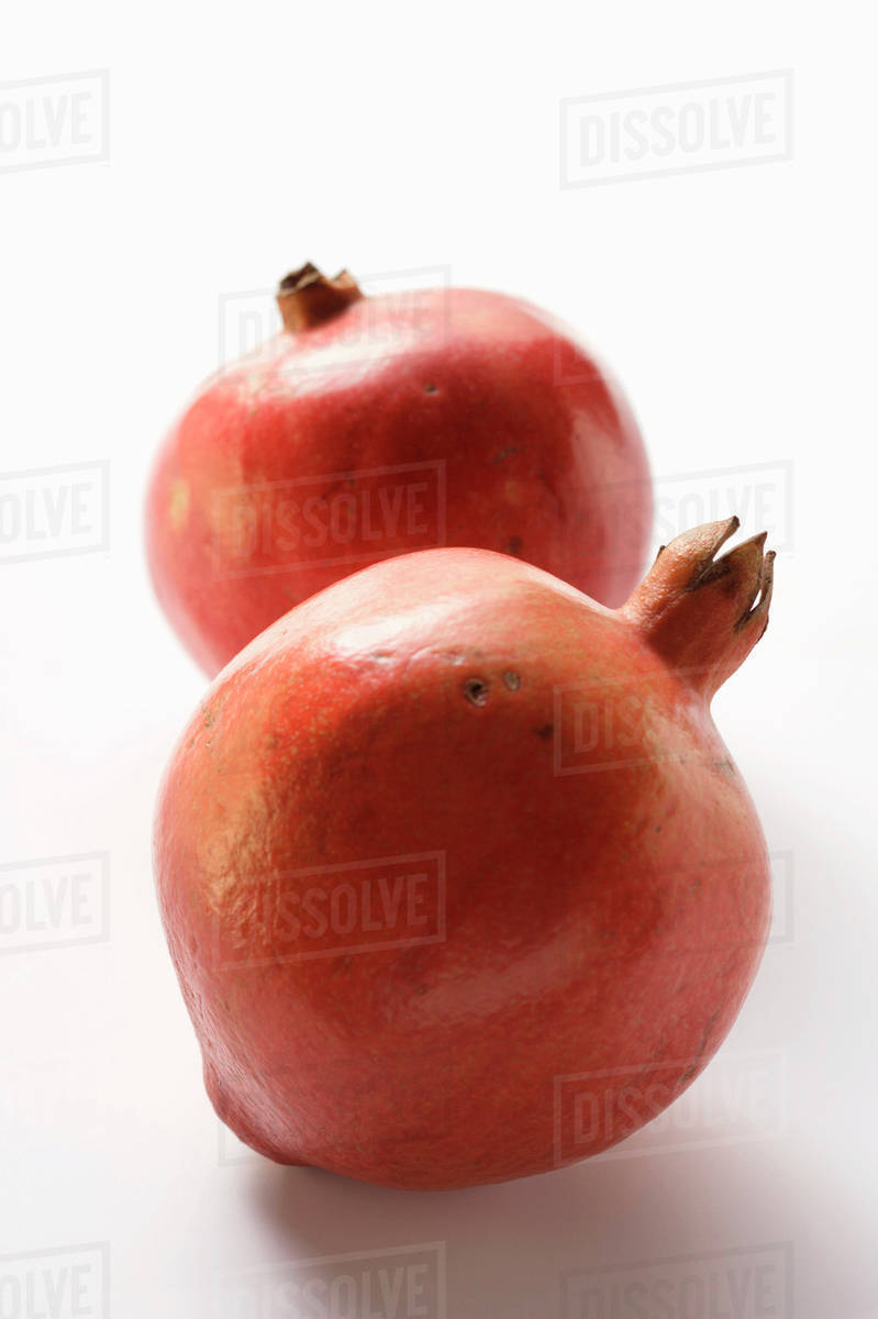 Two whole fresh pomegranates - Royalty-free Stock Photo | Dissolve