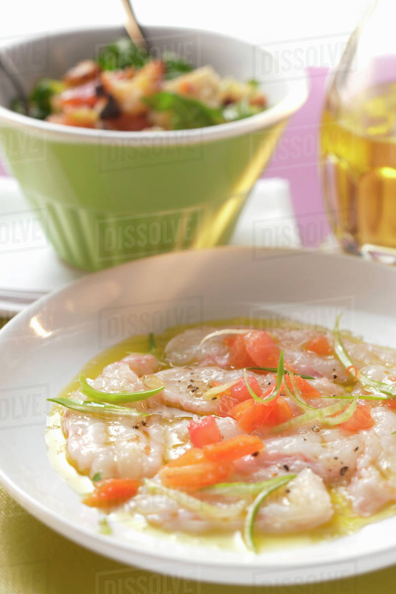 Carpaccio of raw shrimps, tomatoes and spring onions - Stock Photo ...