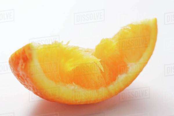 Squeezed wedge of orange - Royalty-free Stock Photo | Dissolve