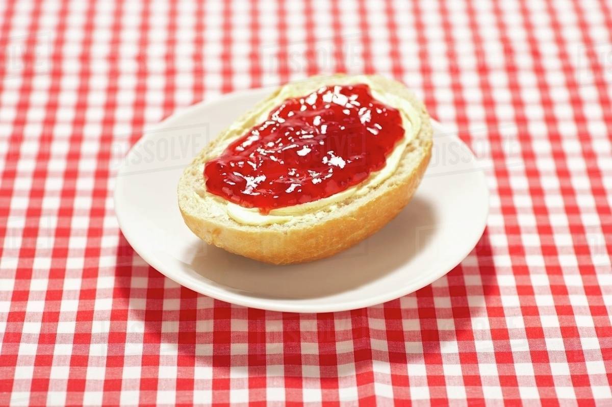 Bread roll with butter and strawberry jam - Royalty-free Stock Photo ...