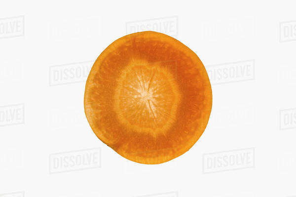 Slice of carrot (cross-section), backlit - Stock Photo - Dissolve