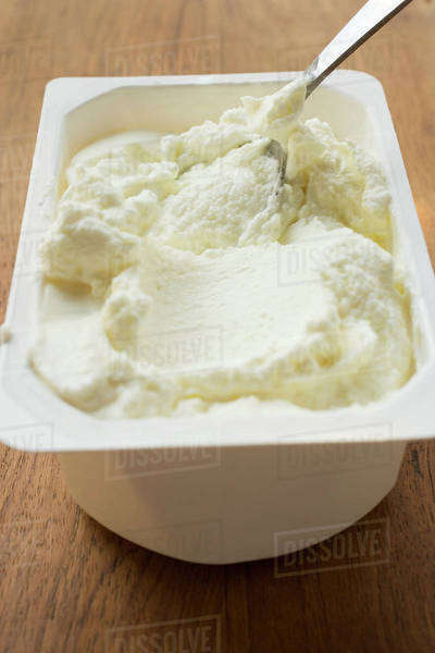 Quark in opened packaging with spoon - Royalty-free Stock Photo | Dissolve