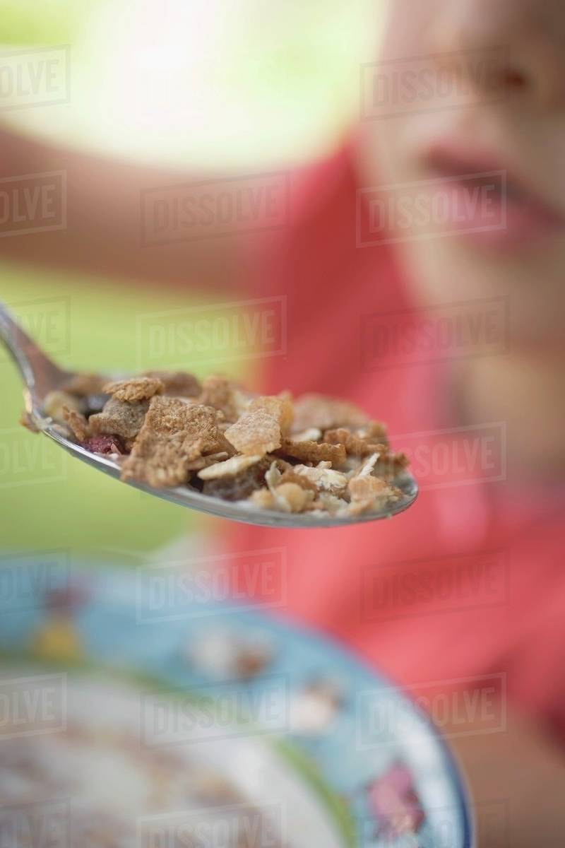 Child eating cereal - Royalty-free Stock Photo | Dissolve