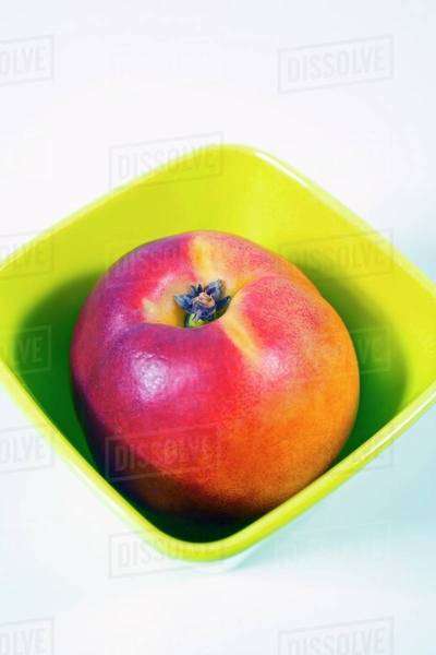 Peach in plastic bowl - Royalty-free Stock Photo | Dissolve
