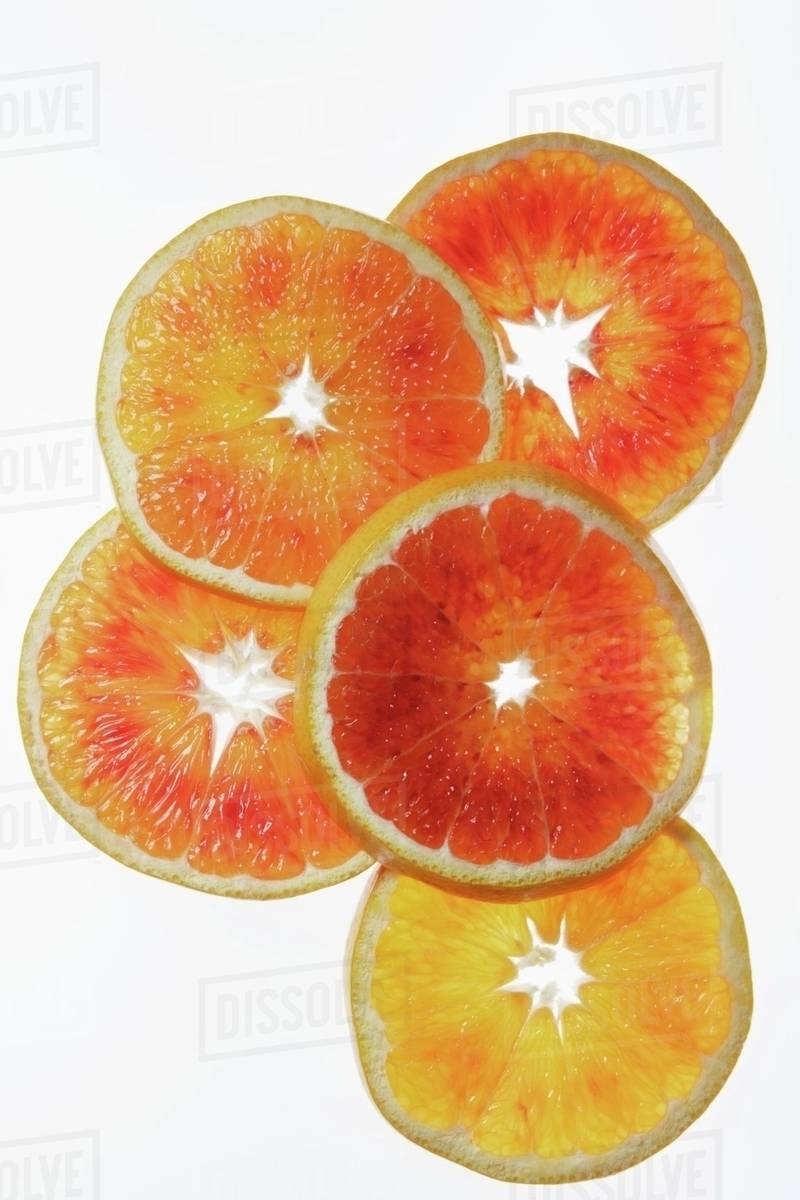 Slices of blood orange, variety 'Tarocco' - Stock Photo - Dissolve