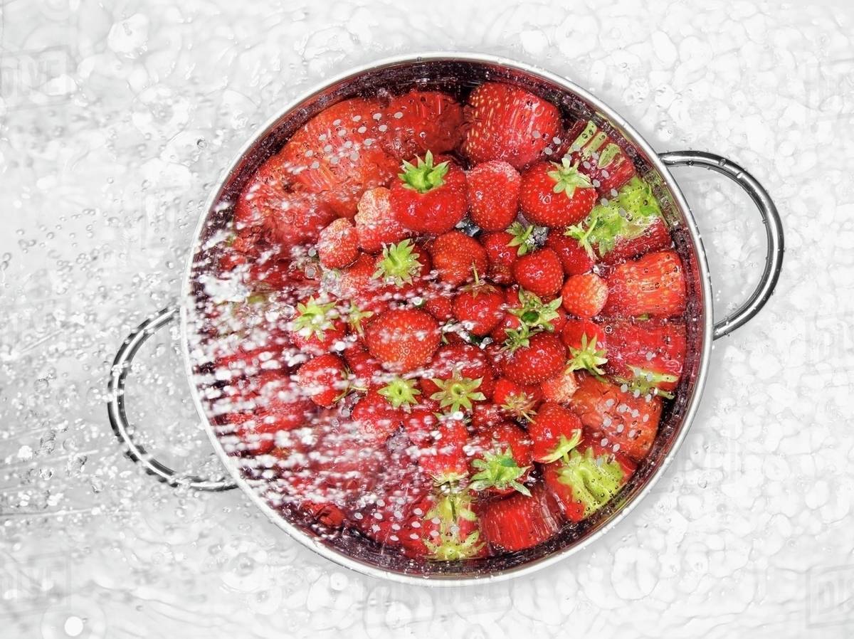Washing strawberries - Royalty-free Stock Photo | Dissolve