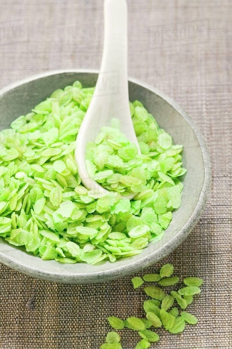 Green rice flakes (unripe rice grains, flattened) - Stock Photo - Dissolve