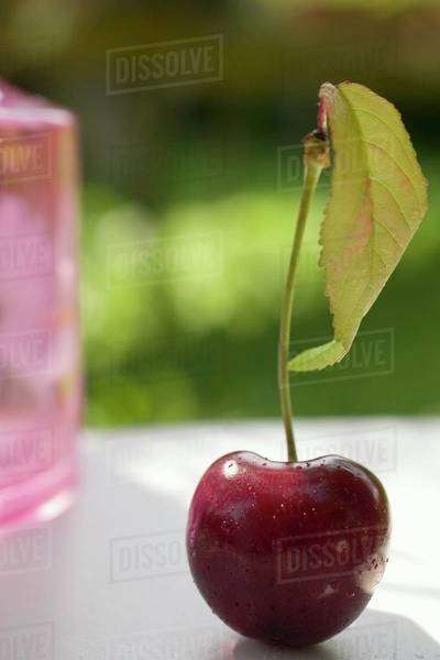 Cherry with stalk and leaf on table in open air - Royalty-free Stock ...