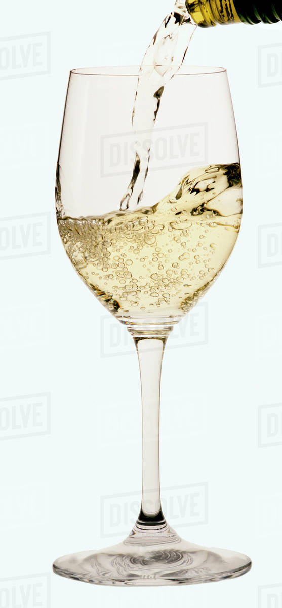 White wine being poured into a white wine glass - Royalty-free Stock ...