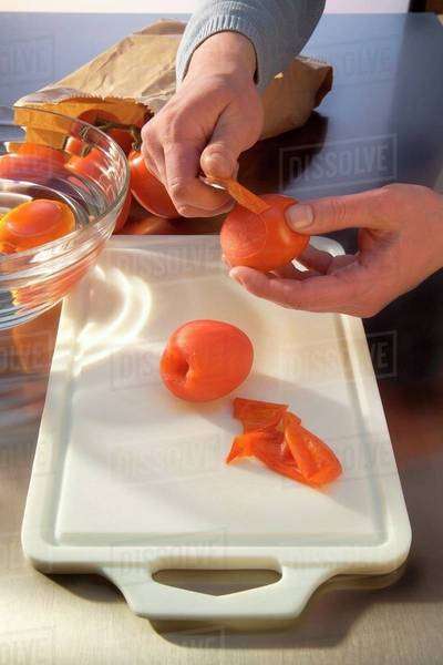 Skinning tomatoes - Stock Photo - Dissolve
