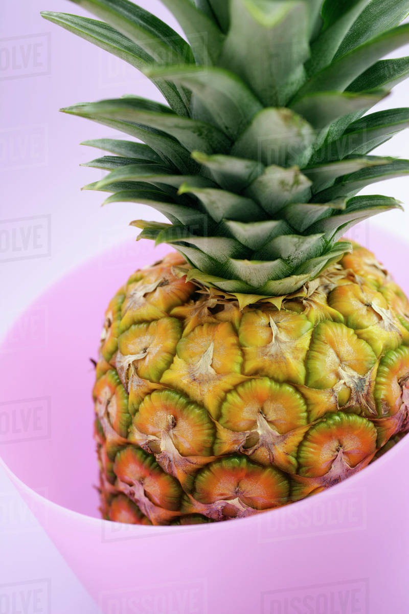 Pineapple in pink plastic container - Royalty-free Stock Photo | Dissolve