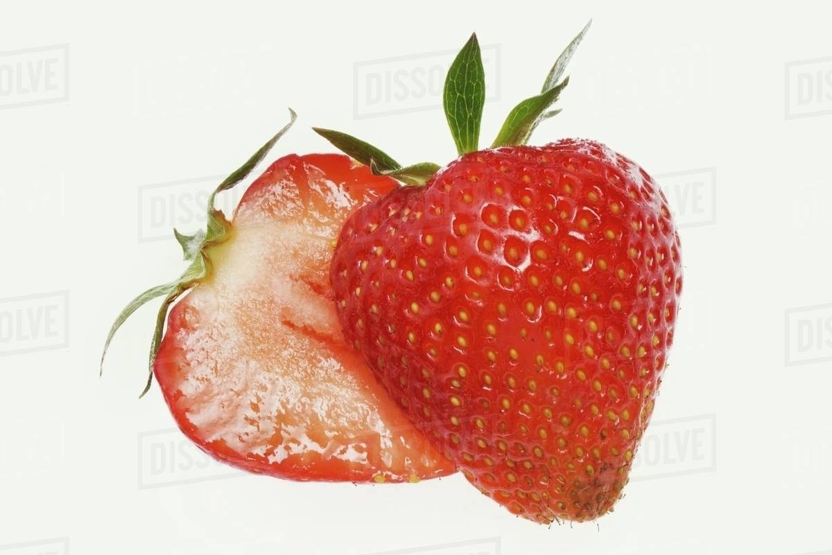 One Strawberry Sliced in Half - Stock Photo - Dissolve