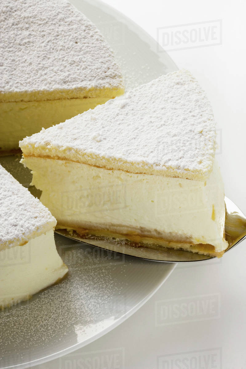 Cream cheesecake, a piece cut, with piece on server - Royalty-free ...