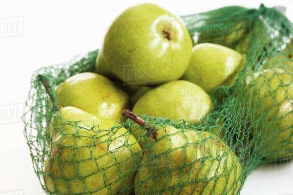 Green pears in net - Royalty-free Stock Photo | Dissolve