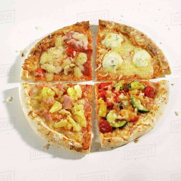 Quarters of four different pizzas - Stock Photo - Dissolve