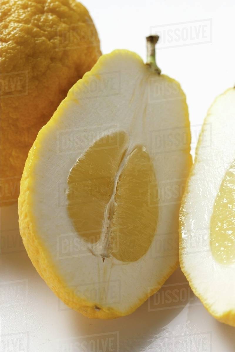 Citrons, whole and halved (close-up) - Stock Photo - Dissolve