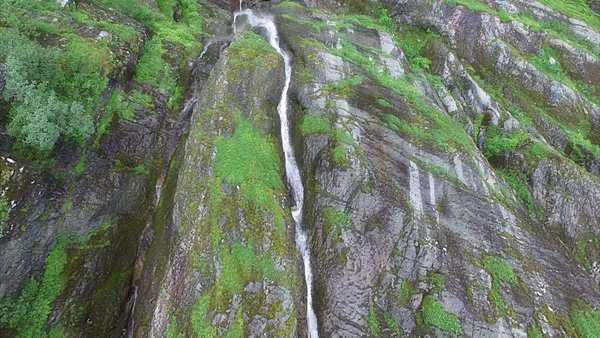 Top down view of thin stream of water running down the slope of rocky ...