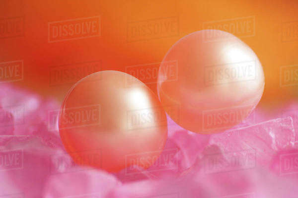 Two bath pearls, close-up - Stock Photo - Dissolve
