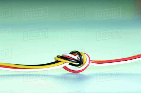 Knotted electrical wires, close-up - Stock Photo - Dissolve