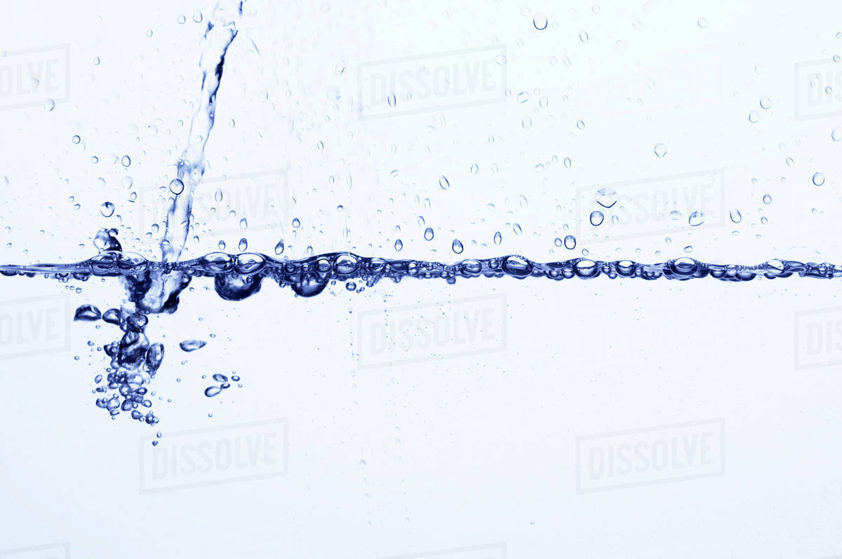 Pouring water, close-up - Stock Photo - Dissolve