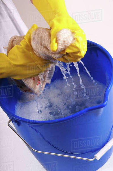 Woman wringing out cleaning rag, elevated view - Stock Photo - Dissolve