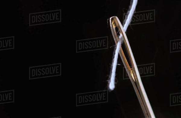 Threaded needle, extreme close up - Stock Photo - Dissolve