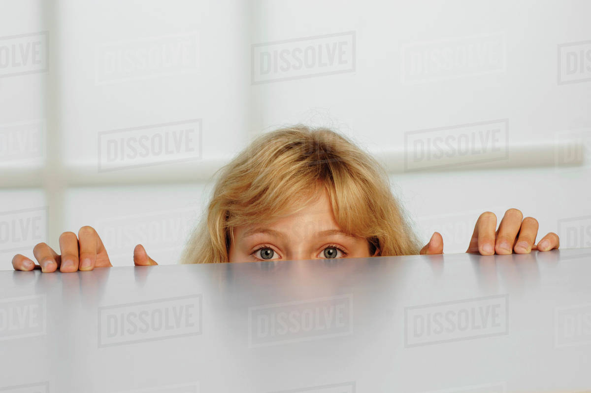 Blond girl hiding - Stock Photo - Dissolve