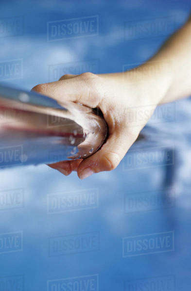 Human hand holding steel bar - Stock Photo - Dissolve
