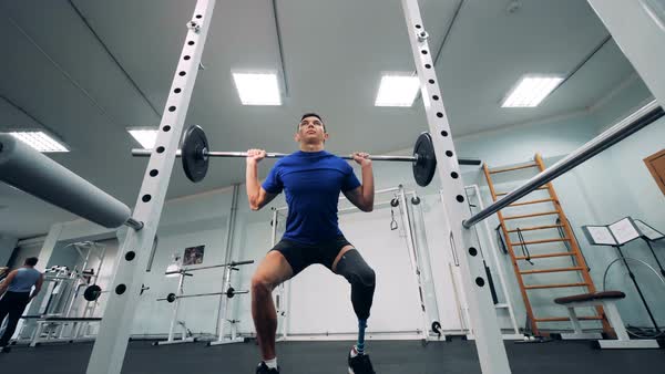 Disabled person squatting with a barbell, bottom view. - 4K Royalty ...