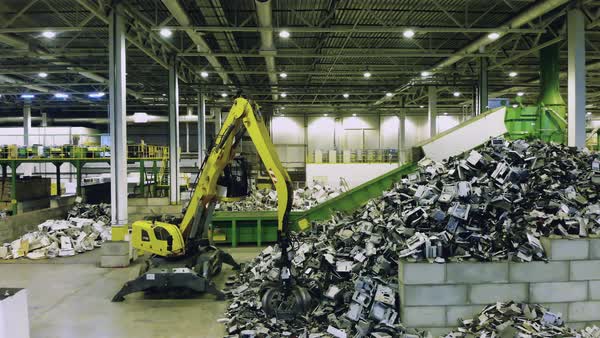 Junkyard unit with a loader grabbing and relocating rubbish. Recycling ...