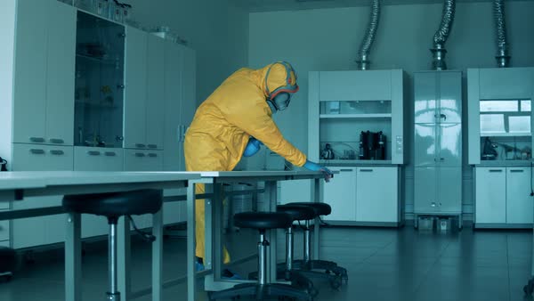 Sanitary worker is disinfecting tables in the laboratory - 4K Royalty ...