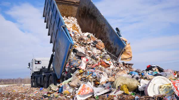 Garbage truck disposed trash on the landfill. Vehicle transporting ...