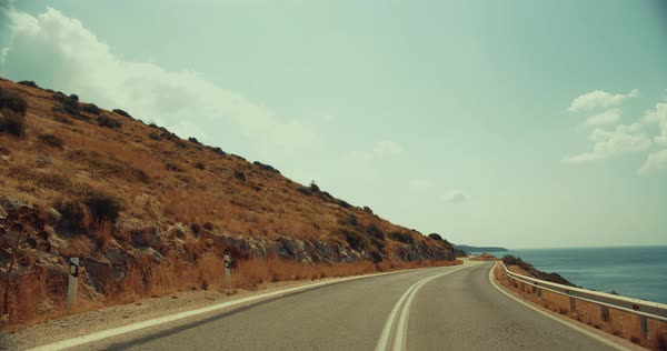 Road along a coastline, next to a cliff. - 4K Royalty-free Stock Video ...